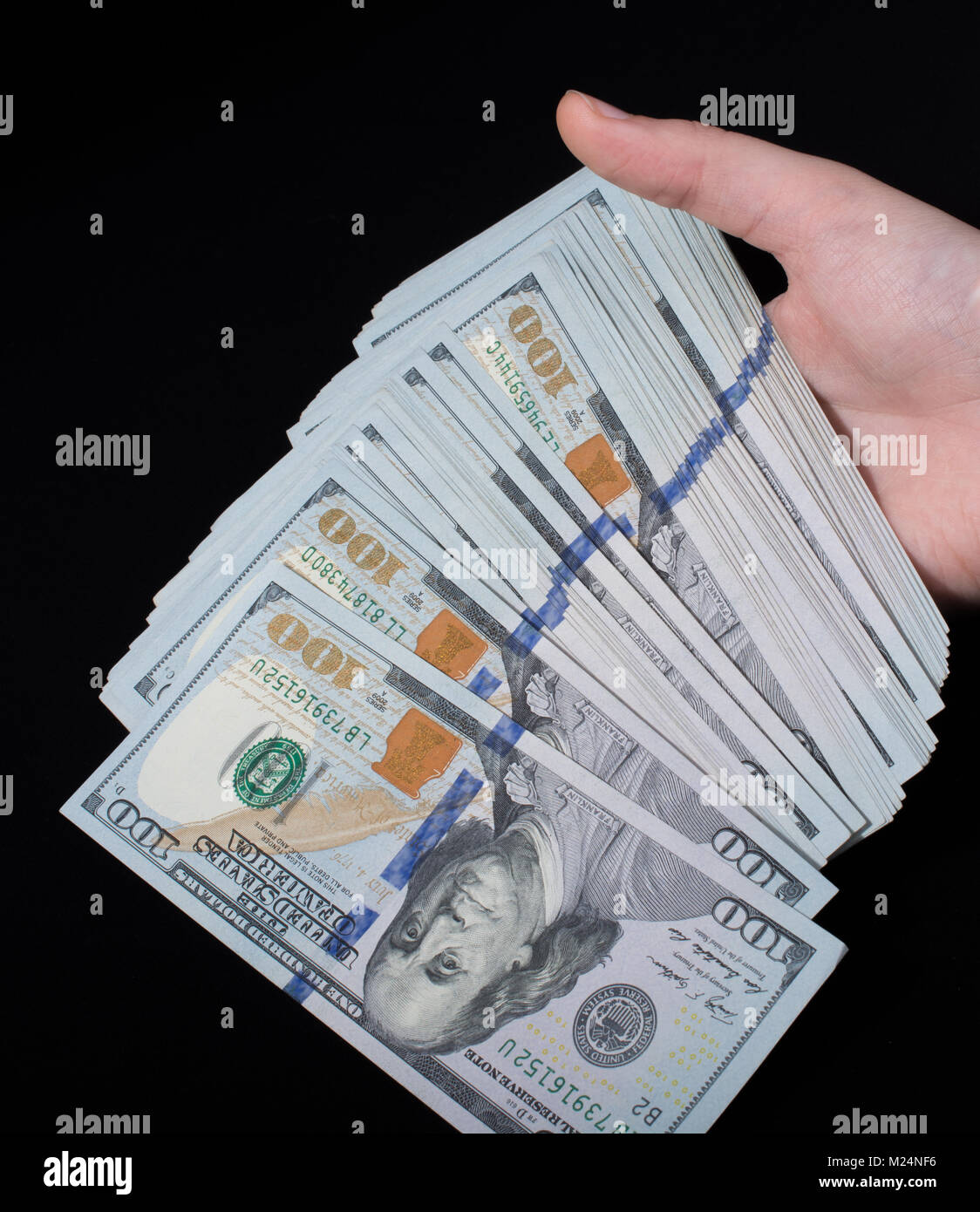 Hand holding American dollar banknotes isolated on white background ...