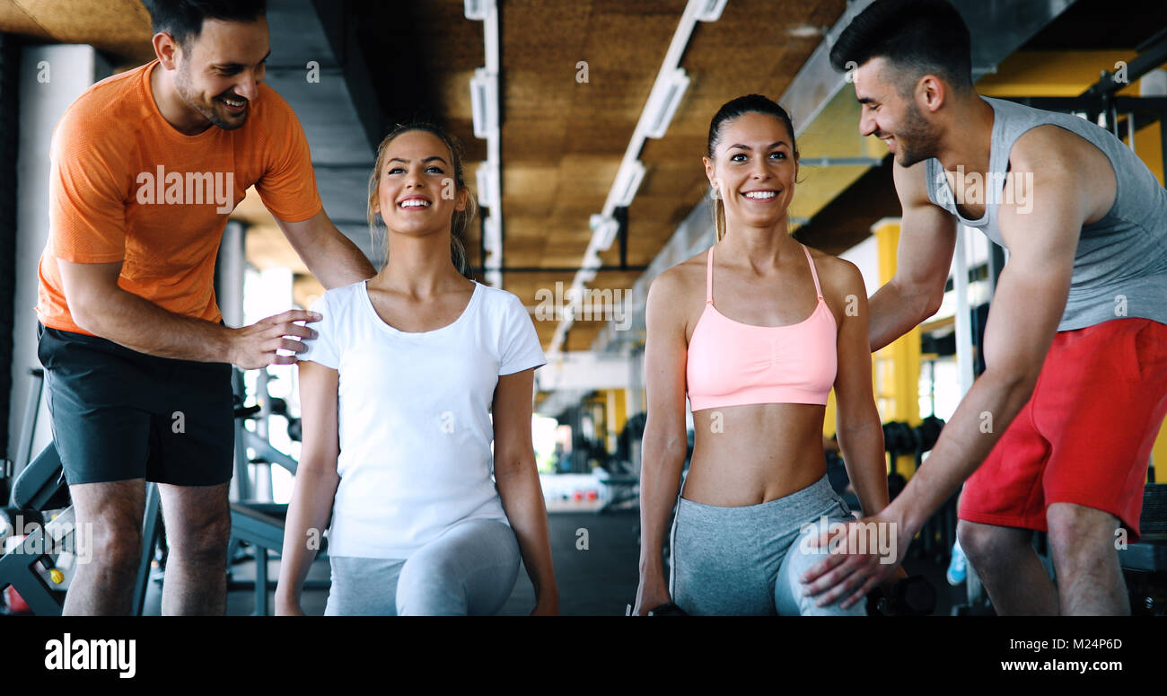 Group of friends exercising together in gym Stock Photo - Alamy