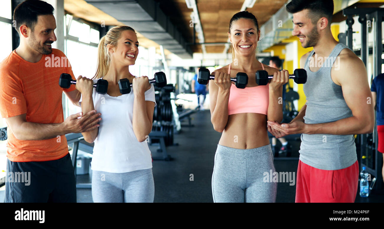 Group of friends exercising together in gym Stock Photo - Alamy