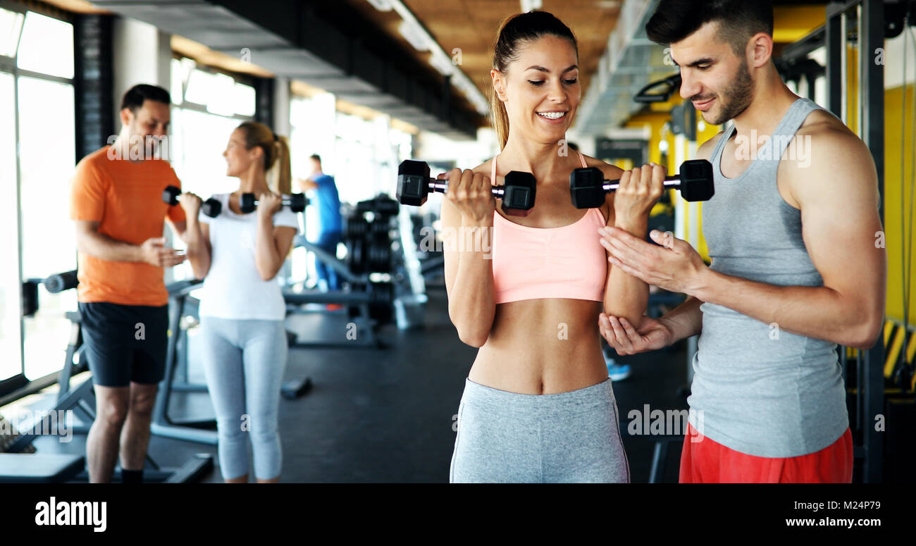 Group of friends exercising together in gym Stock Photo - Alamy