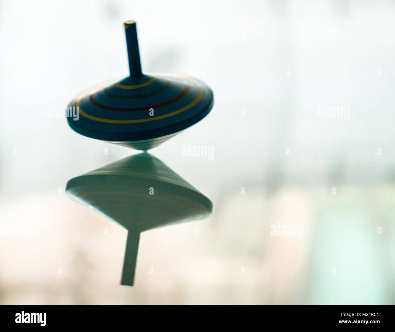 Spinning top in action on a mirror surface Stock Photo - Alamy
