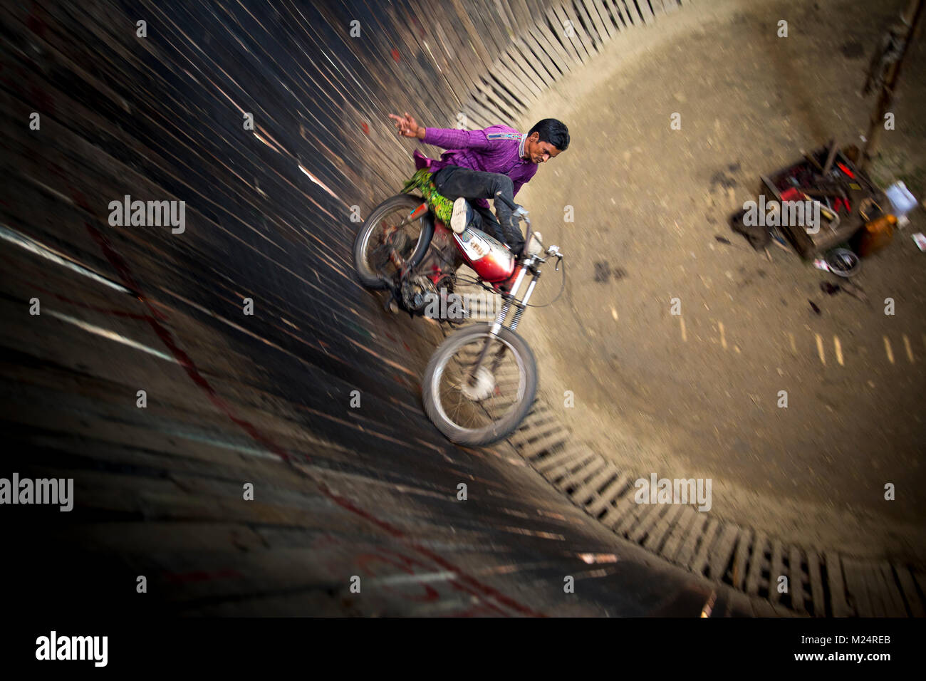 A dangerous motorbike carnival sideshow featuring a stunt biker takes ...