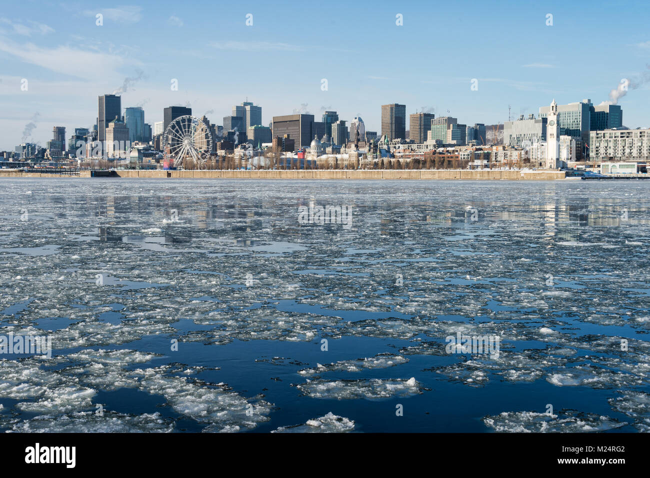 Montreal Skyline in winter, with chunks of ice floating on the Saint ...