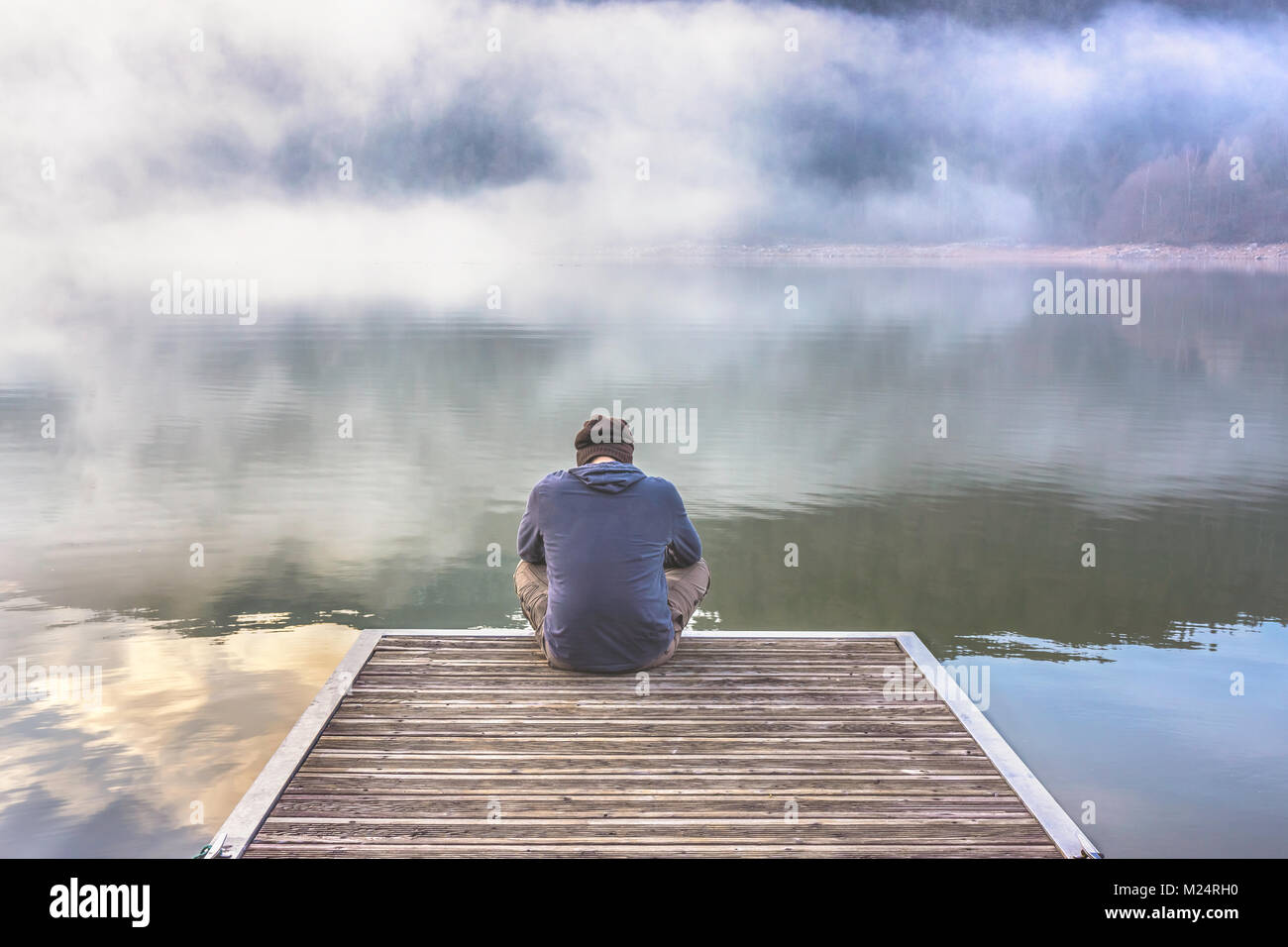 Man sitting on dock hi-res stock photography and images - Alamy