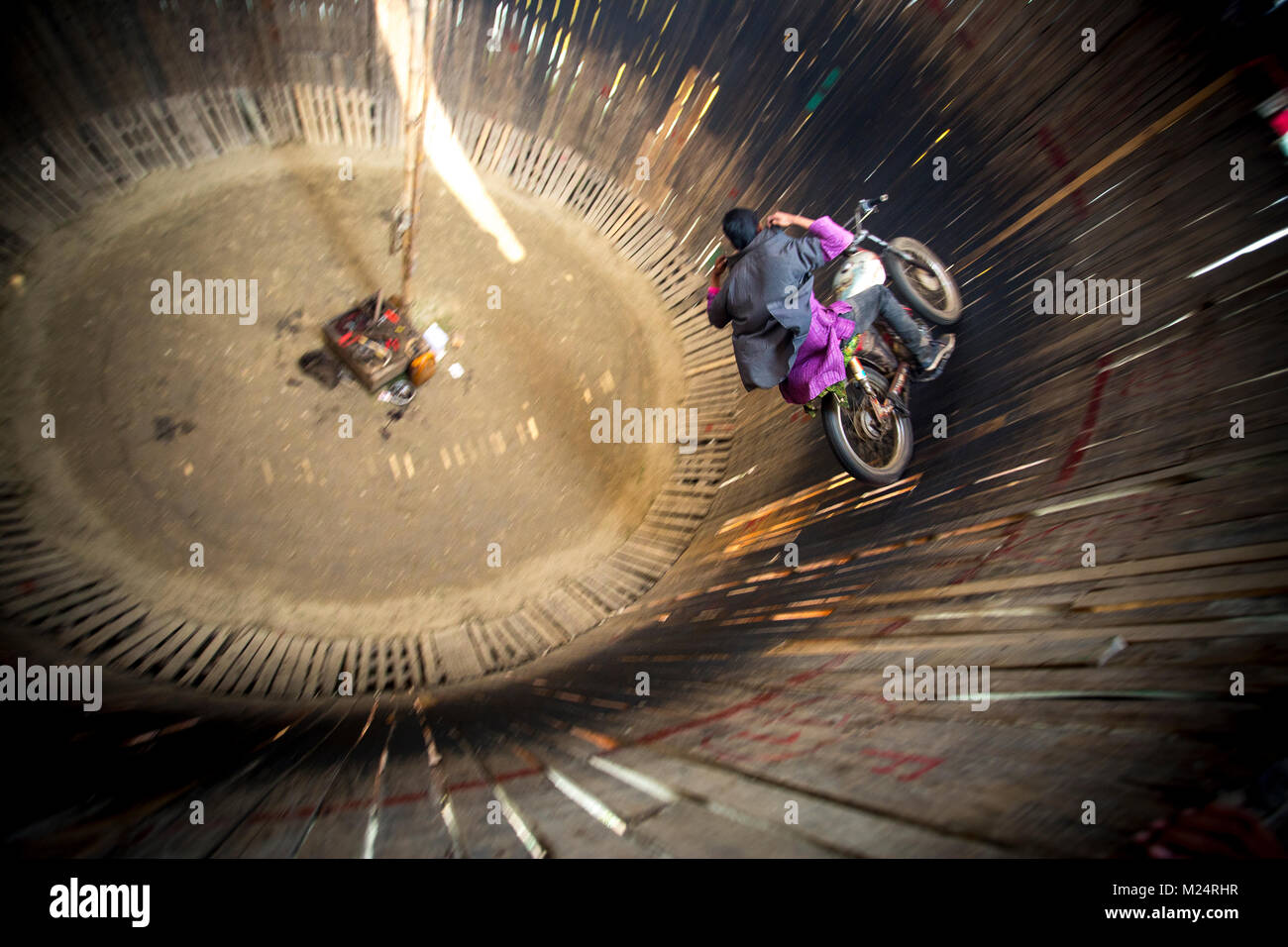 A dangerous motorbike carnival sideshow featuring a stunt biker takes ...