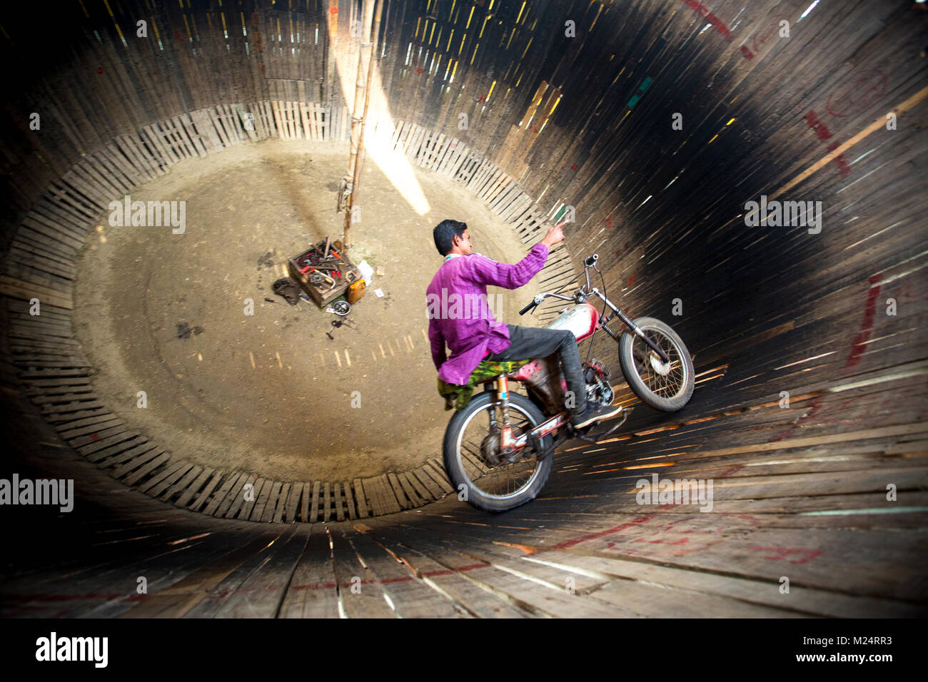 A dangerous motorbike carnival sideshow featuring a stunt biker takes ...