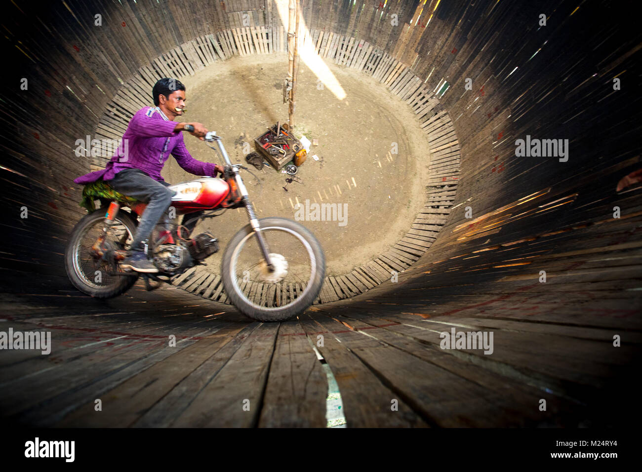 A dangerous motorbike carnival sideshow featuring a stunt biker takes ...
