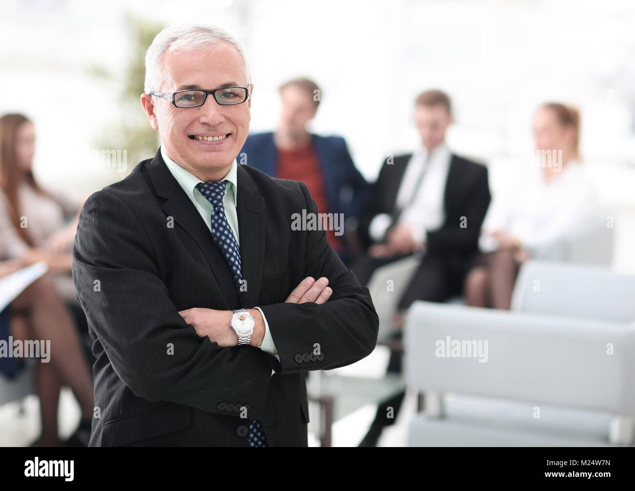 smiling senior boss in the background of the office Stock Photo - Alamy