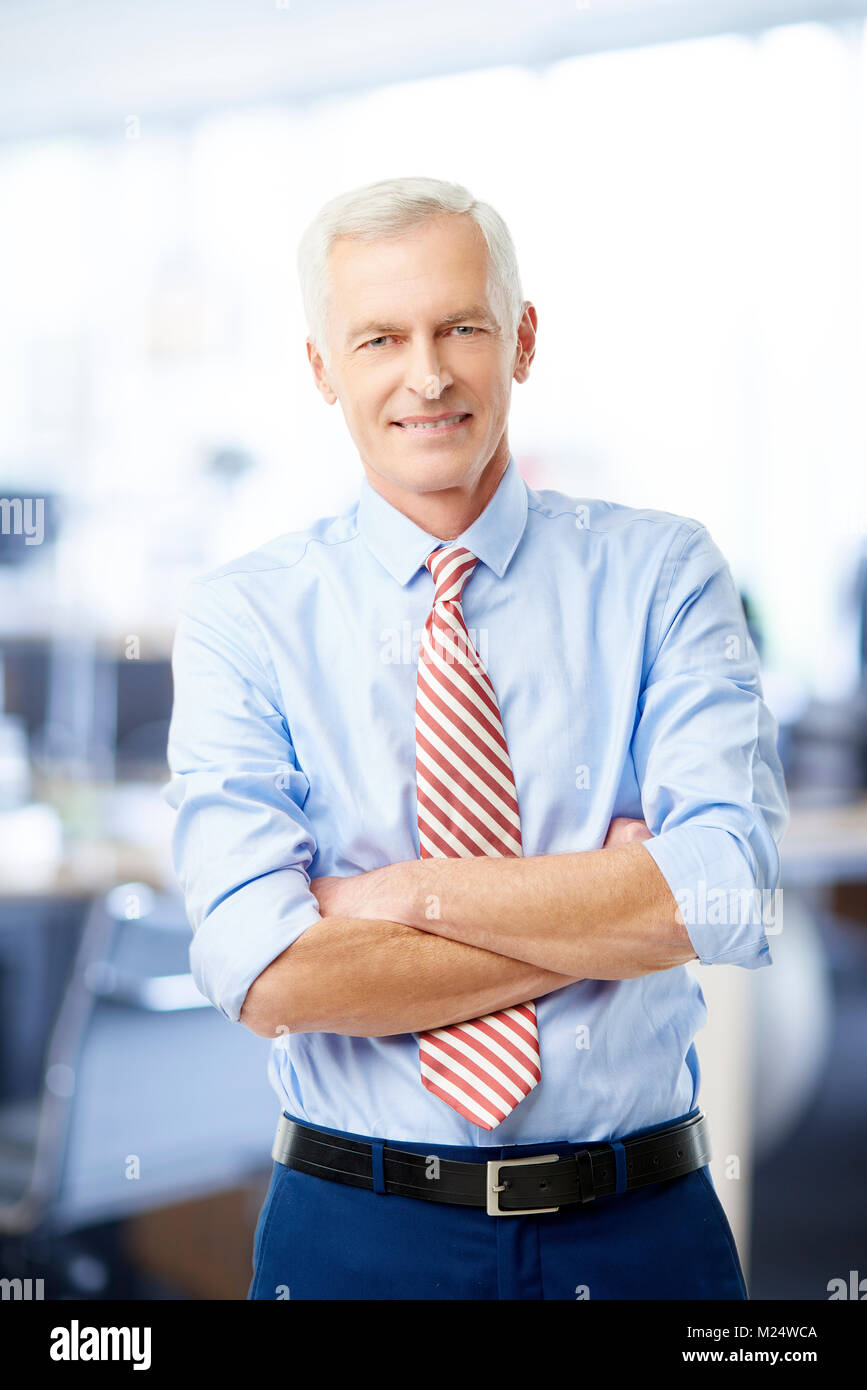 An executive senior financial advisor businessman standing with arms ...