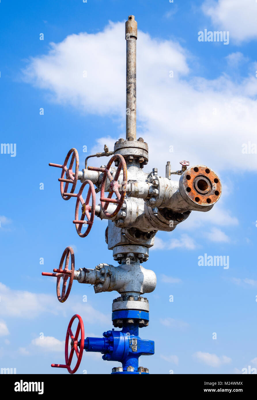 Oil well after repair in mud and puddles. Oil well wellhead equipment ...