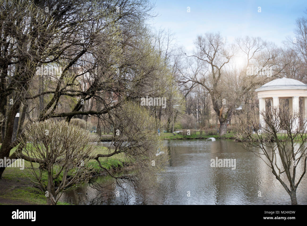 The pavilion on the bank of the lake in the spring park at the ...