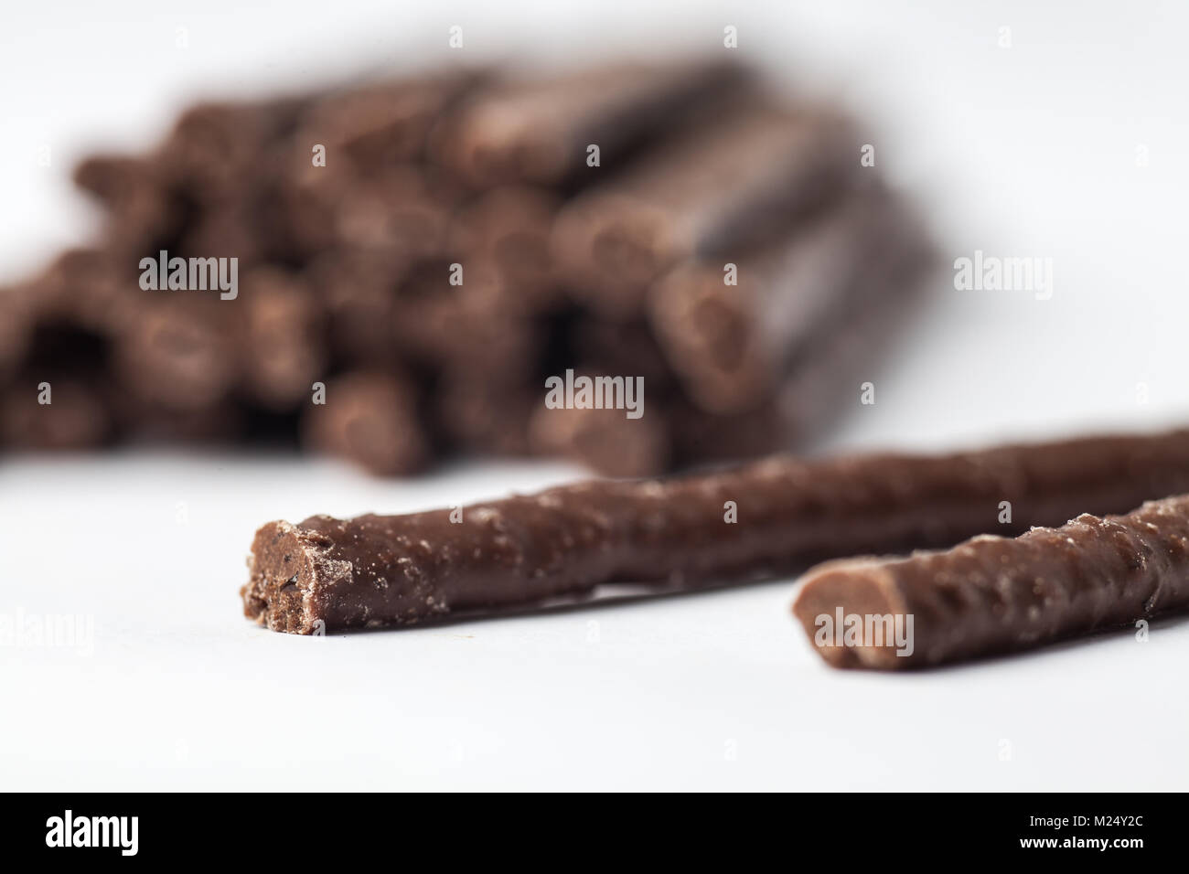 Chocolate Flavoured Stick Candy close up with pile in background Stock ...