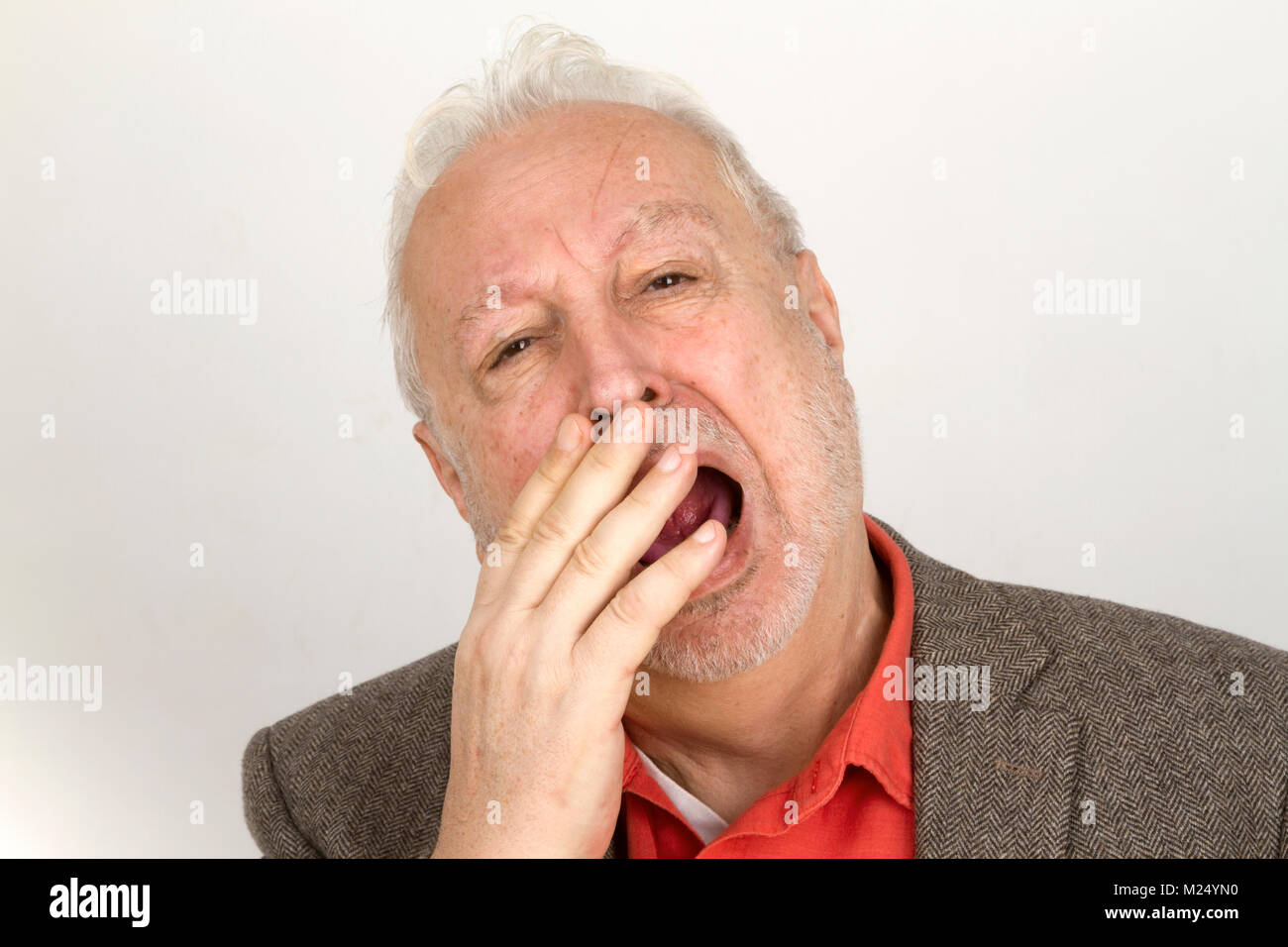 Bearded man yawning - on bright background Stock Photo - Alamy