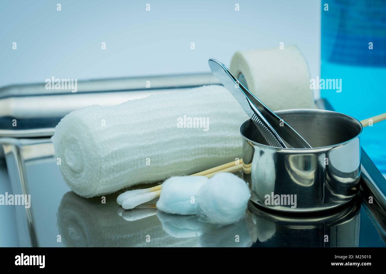 Wound care dressing set on stainless steel plate. Cotton ball with ...