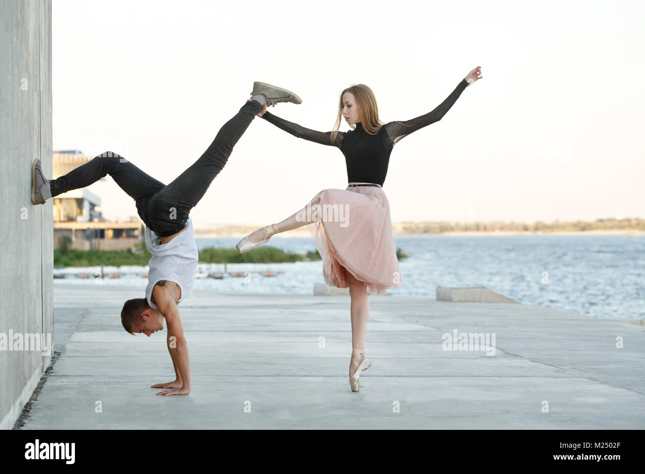 A slender ballerina dances with a modern dancer. Date of lovers ...