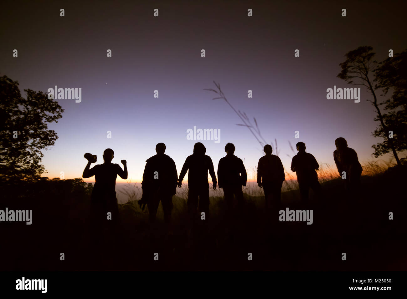 Happy friends, family jumping together in a circle having fun and ...