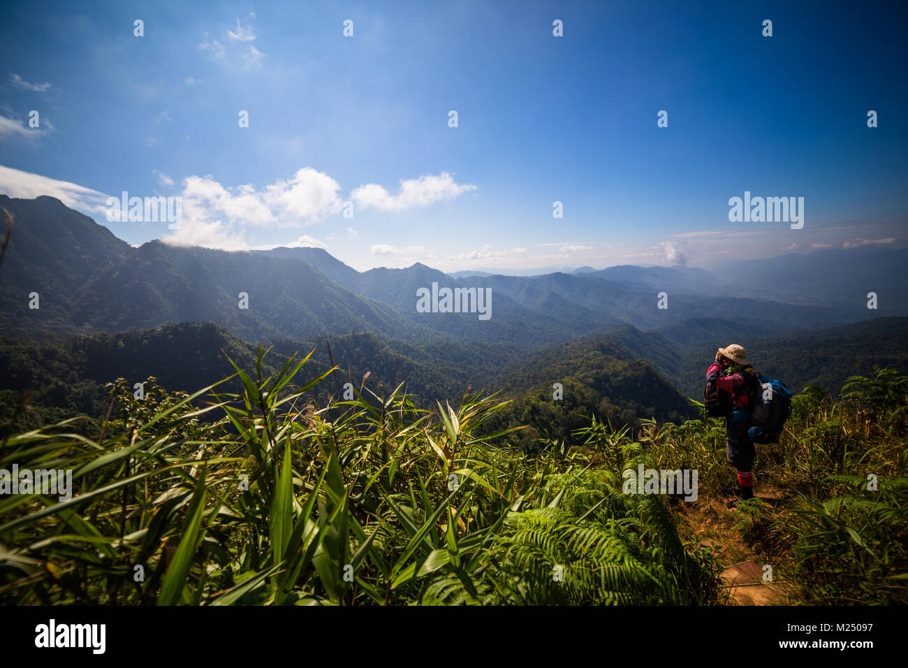 Freedom man standing on mountain and take a photo Stock Photo - Alamy