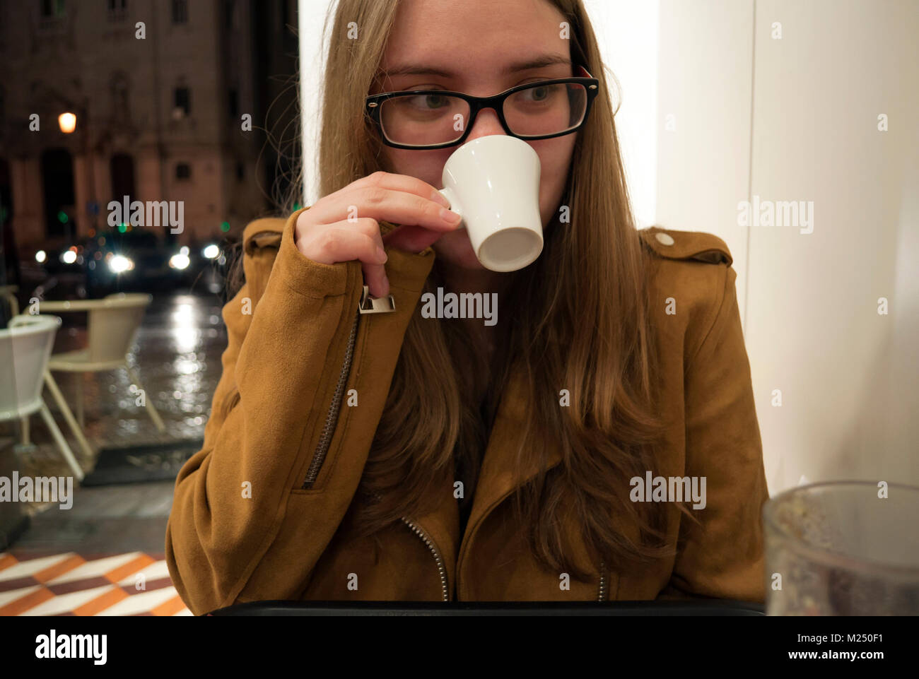 Young woman drinking coffee Stock Photo - Alamy