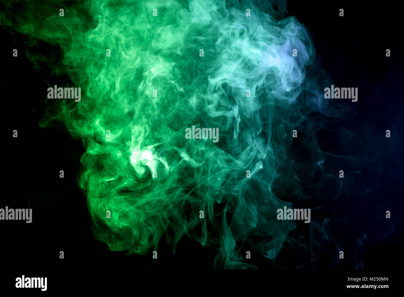 Cloud of smoke of blue and green colors on black isolated background ...