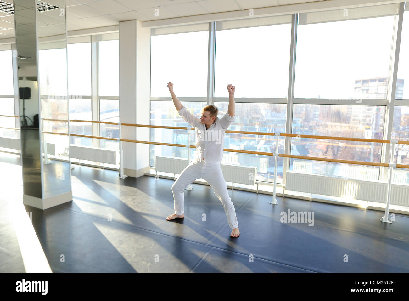 Blonde male person spotting in white suit Stock Photo - Alamy
