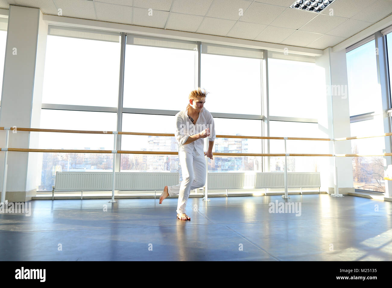 Guy spotting in white suit and raving at studio Stock Photo - Alamy