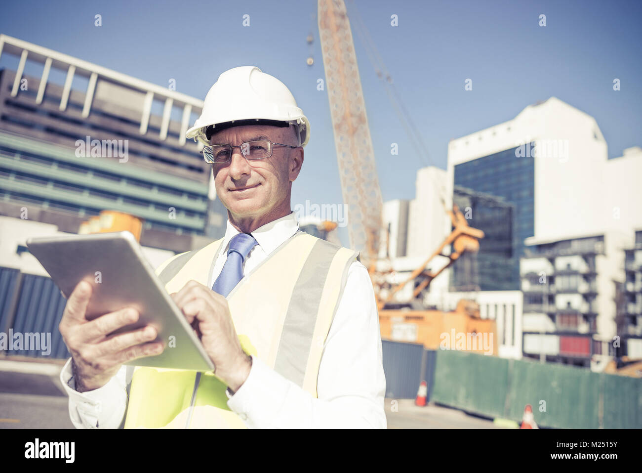 Construction manager controlling building site and tablet device Stock ...