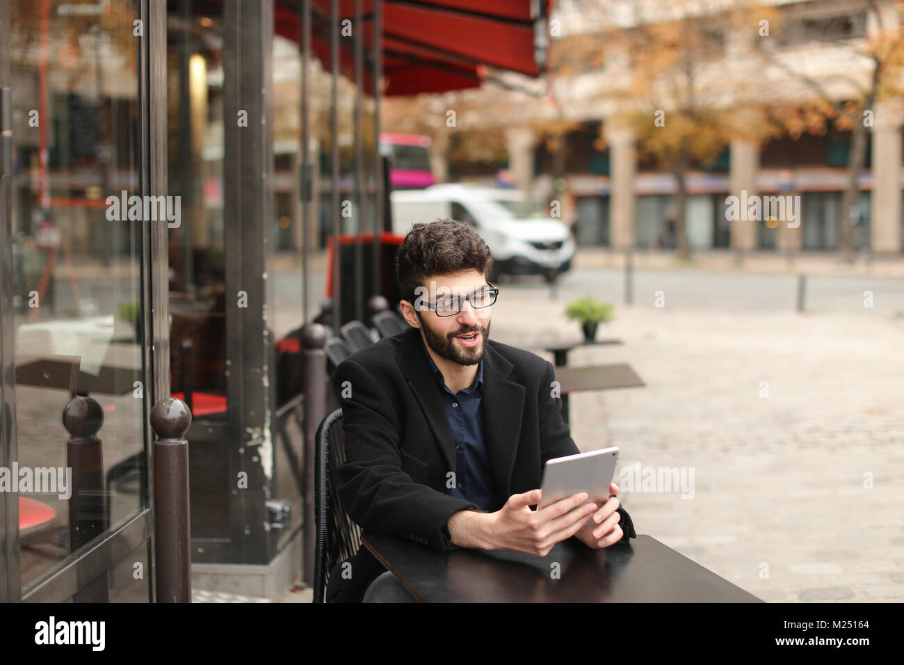 Online poker player using tablet at cafe table in Stock Photo - Alamy