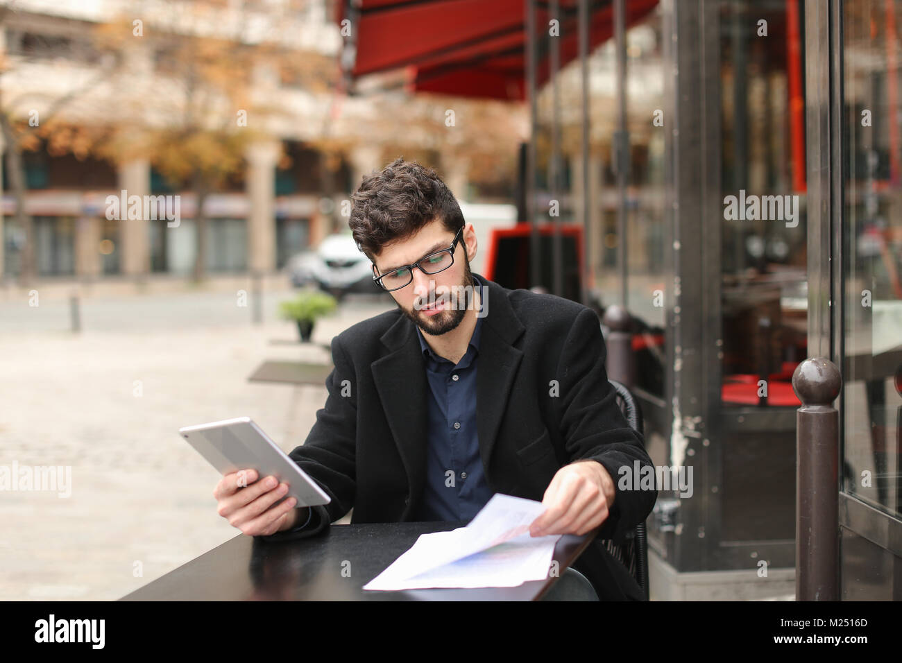 Statistician working with diagram and tablet at cafe table Stock Photo ...