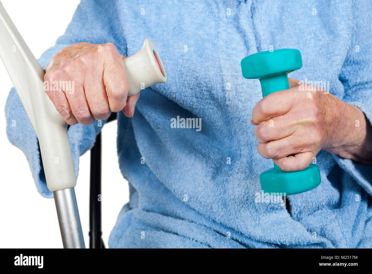Close up picture of old disabled lady holding a blue dumbell and crutch ...