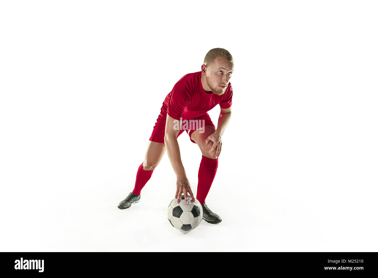 Professional football soccer player with ball isolated white background ...