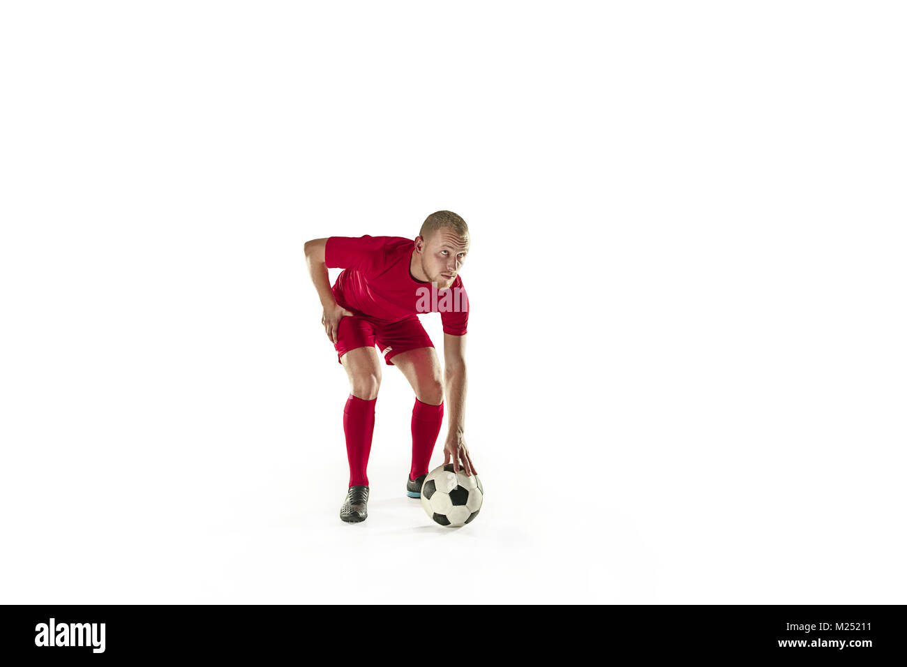 Professional football soccer player with ball isolated white background ...