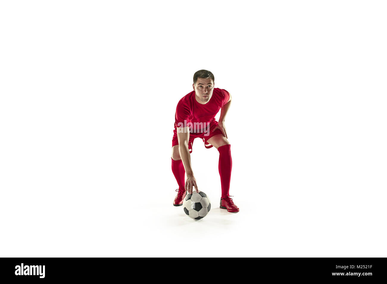 Professional football soccer player with ball isolated white background ...