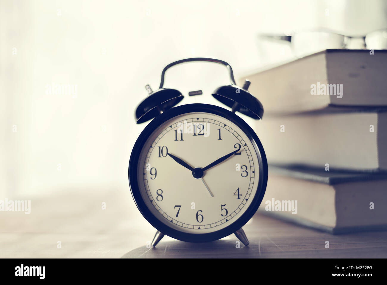 Alarm clock and Books Stock Photo - Alamy