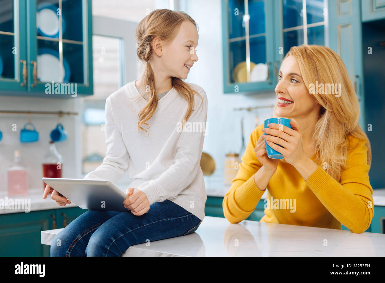 Delighted mother and daughter spending time together Stock Photo - Alamy