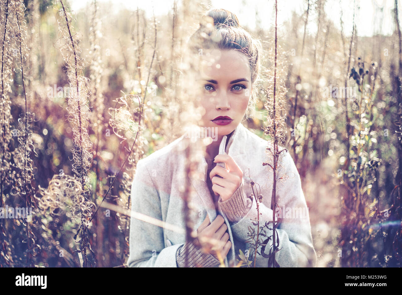 Outdoor fashion photo of young beautiful lady in autumn landscape with ...