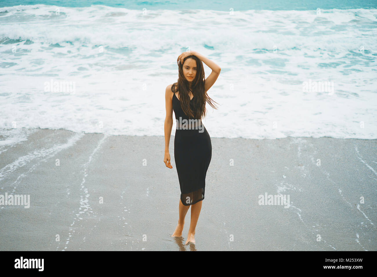 Outdoor photo of beautiful young woman walking at the sea Stock Photo ...