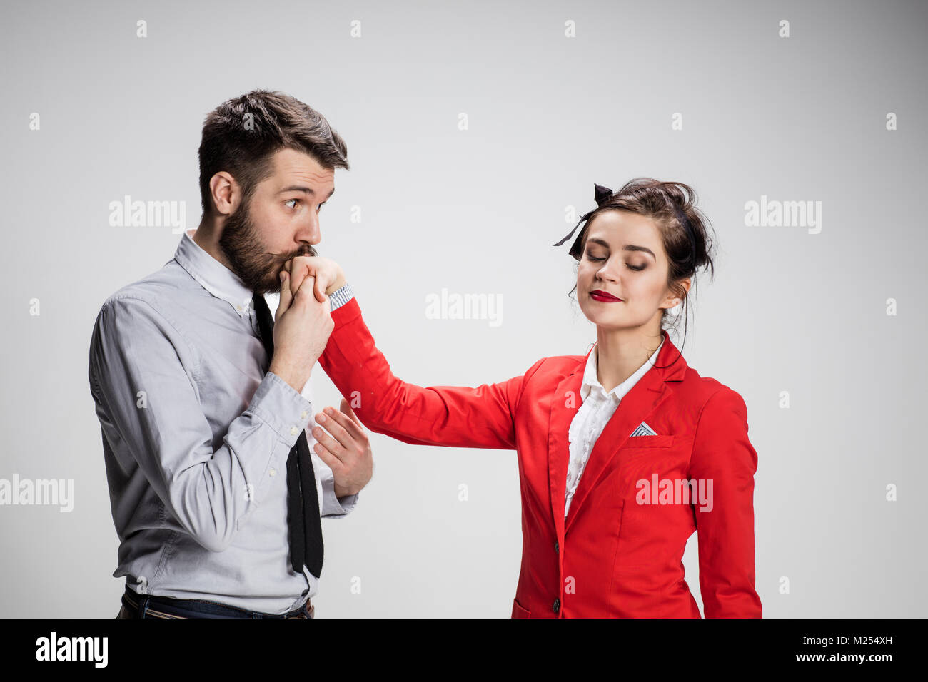 The business man and woman communicating on a gray background Stock ...