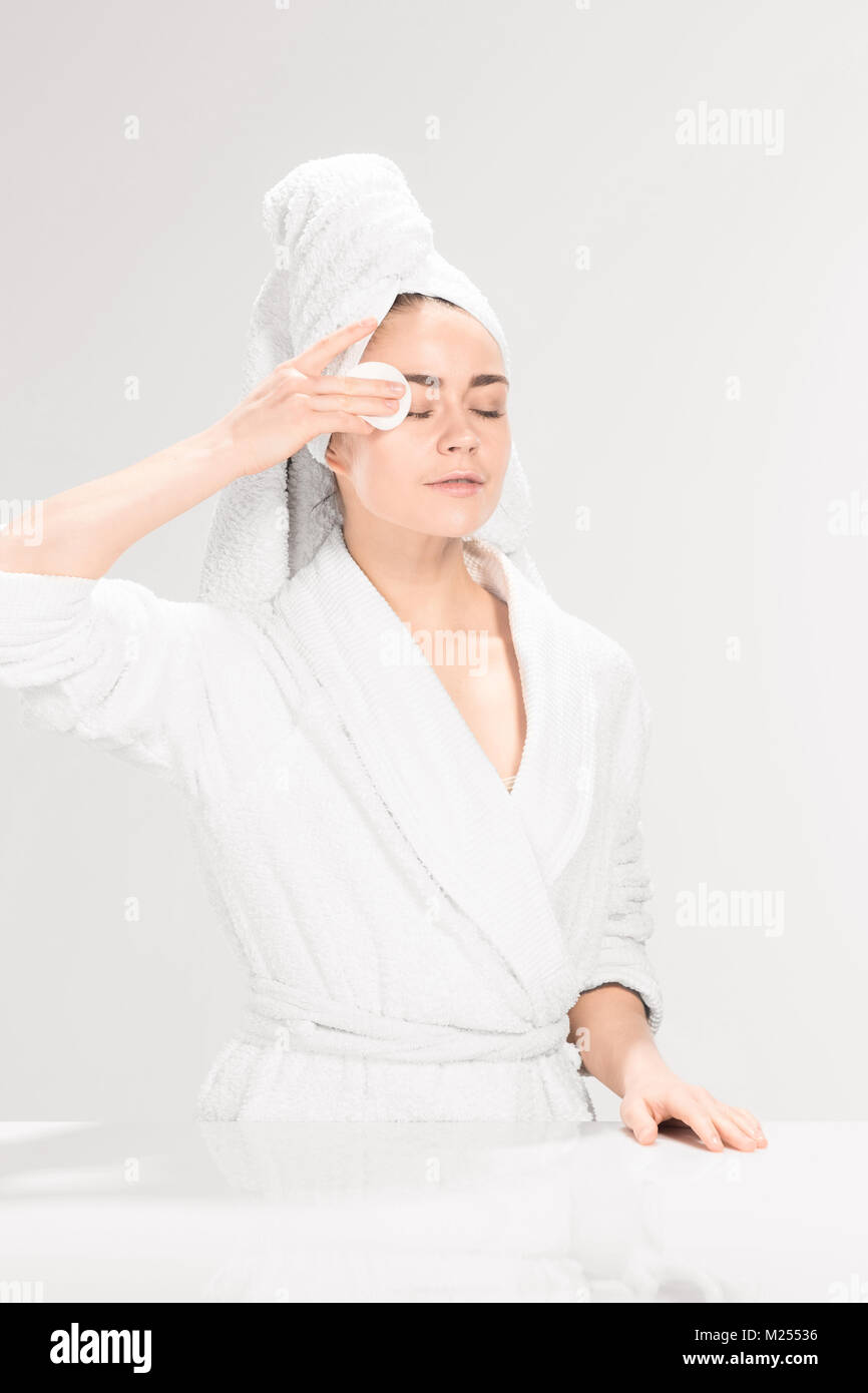 Woman cleaning face in bathroom Stock Photo - Alamy