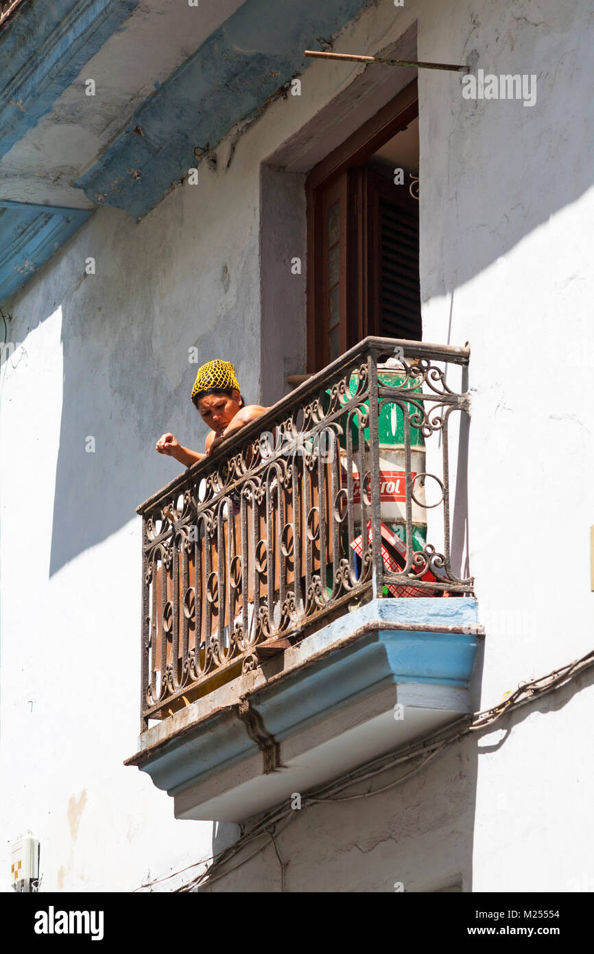 Woman looking down from balcony hi-res stock photography and images - Alamy