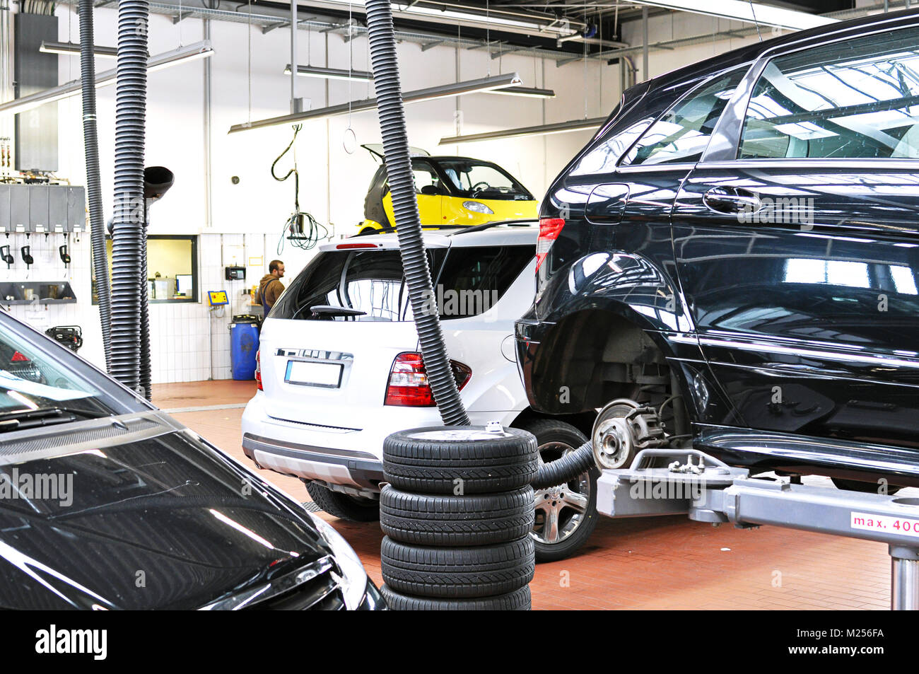 vehicles in a garage - repair and inspection of cars on a lifting ...