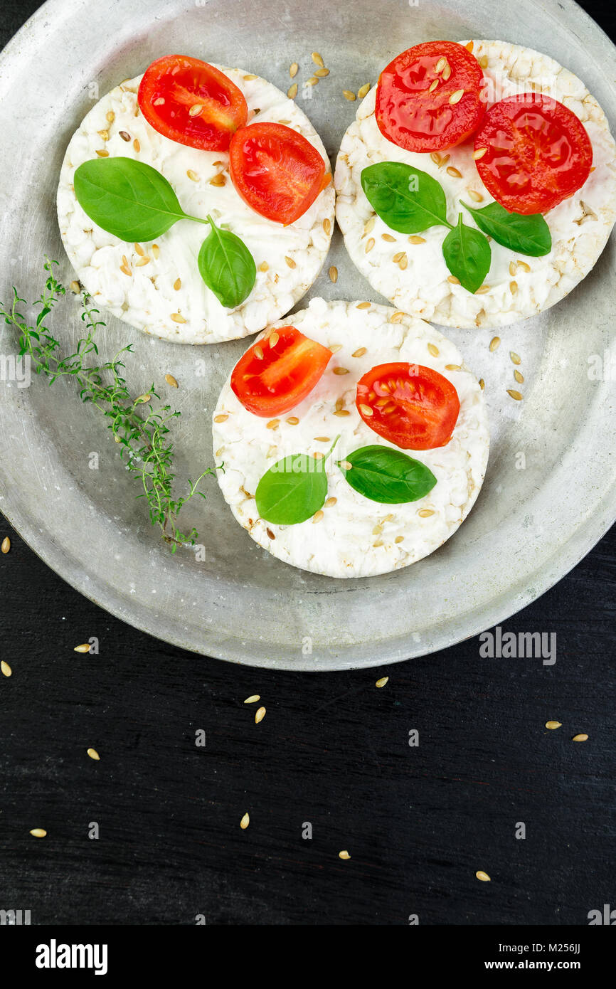 Healthy Rice Cakes with cherry tomatoes, cheese feta, basil and sesame ...