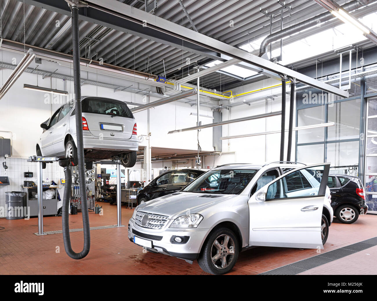 vehicles in a garage - repair and inspection of cars on a lifting ...