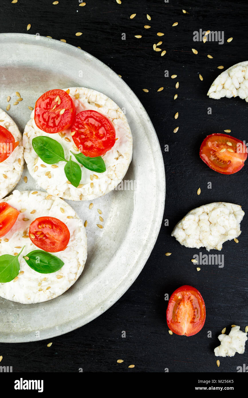 Healthy Rice Cakes with cherry tomatoes, cheese feta, basil and sesame ...