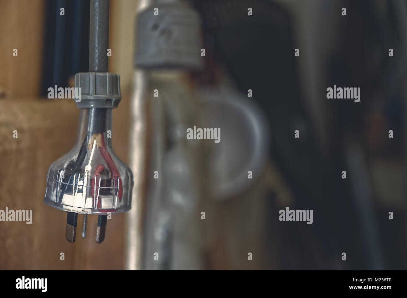 Extension cord hanging in workshop Stock Photo - Alamy