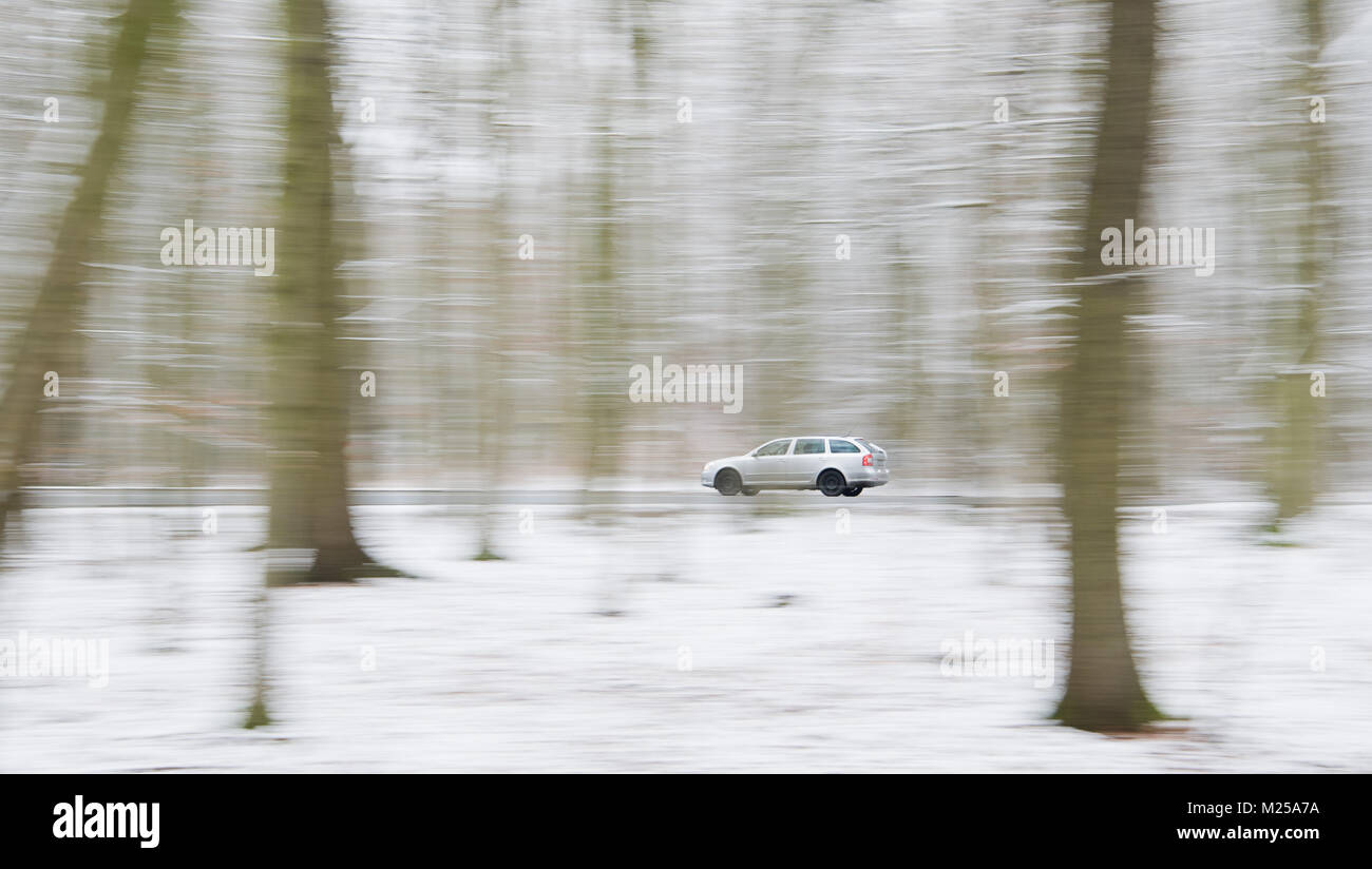 Sehnde, Germany. 05th Feb, 2018. A car driving through a snowy forest ...