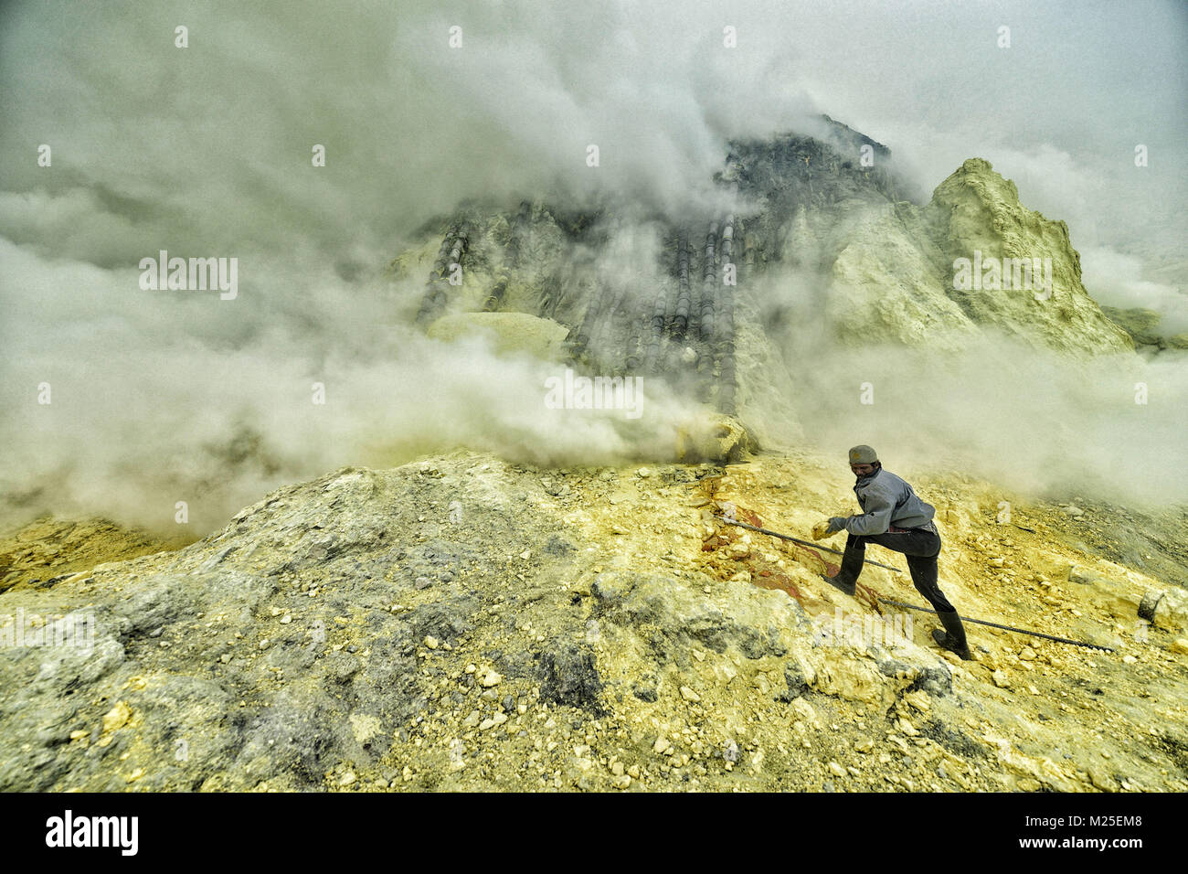 Java, Indonesia. 11th Aug, 2016. A miner picking up pieces of sulfur ...