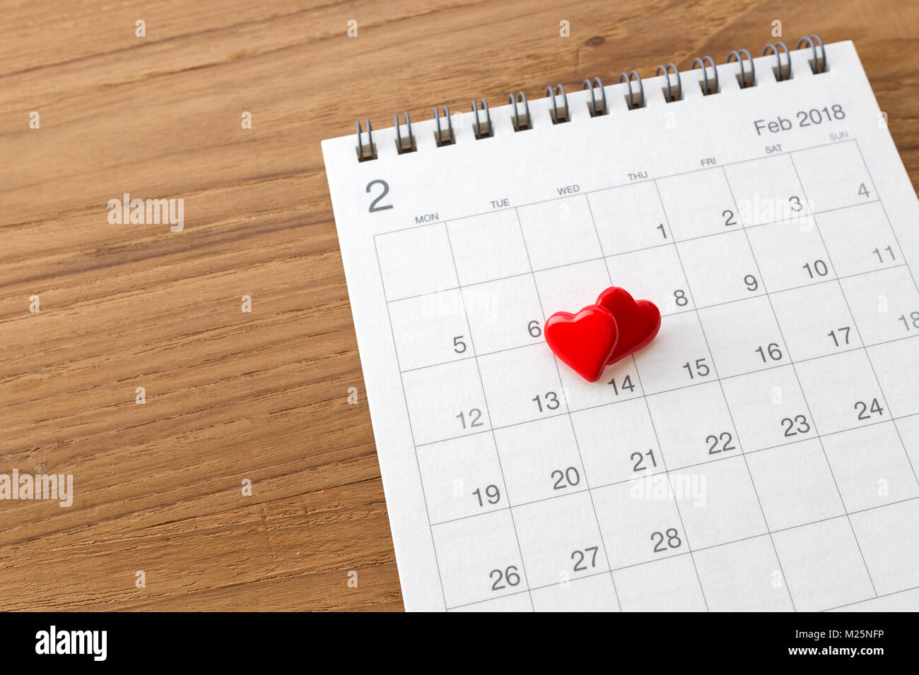 Hearts on calendar February 14 valentines day on wooden table ...