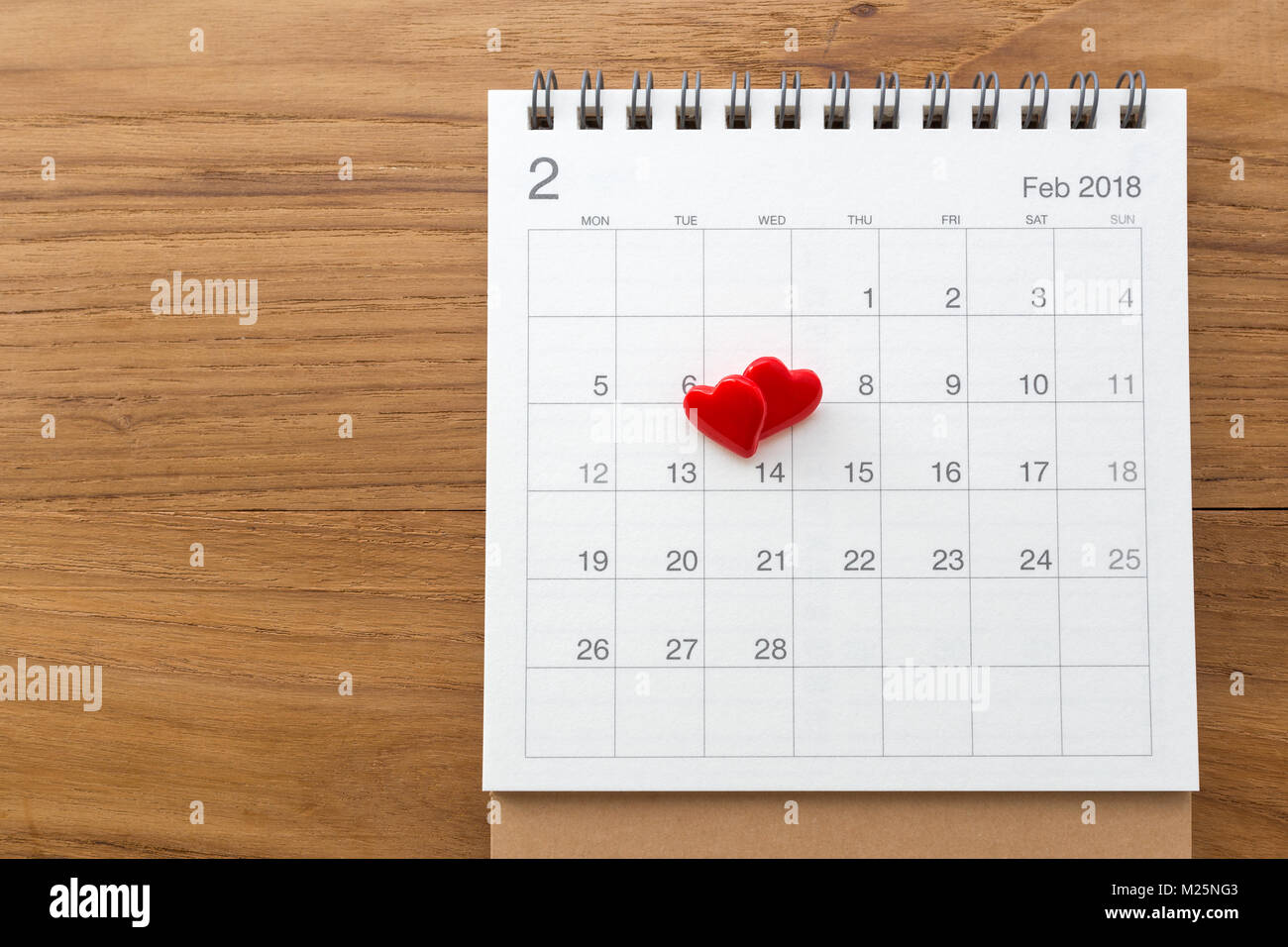 Hearts on calendar February 14 valentines day on wooden table ...