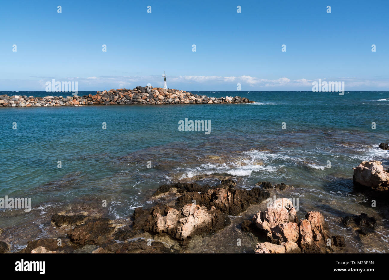 The small harbour entrance to Sisi a popular fishing and holiday resort ...