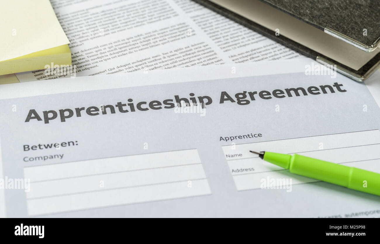 An Apprenticeship agreement with a pen on a desk Stock Photo - Alamy